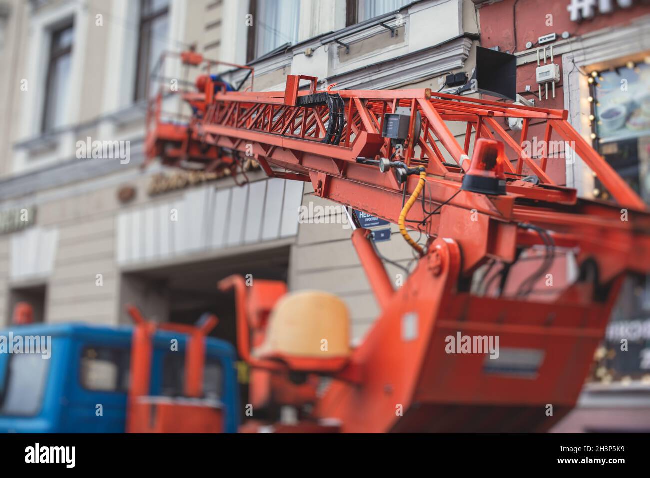 Aerial work platform vehicle during facade decoration, orange ...