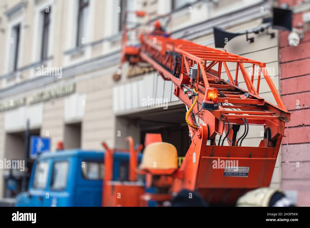 Aerial work platform vehicle during facade decoration, orange ...
