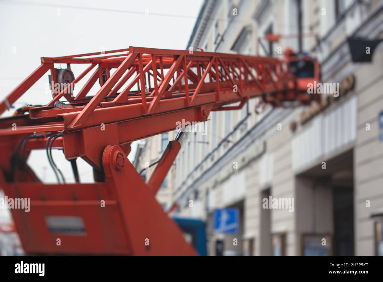 Aerial work platform vehicle during facade decoration, orange ...