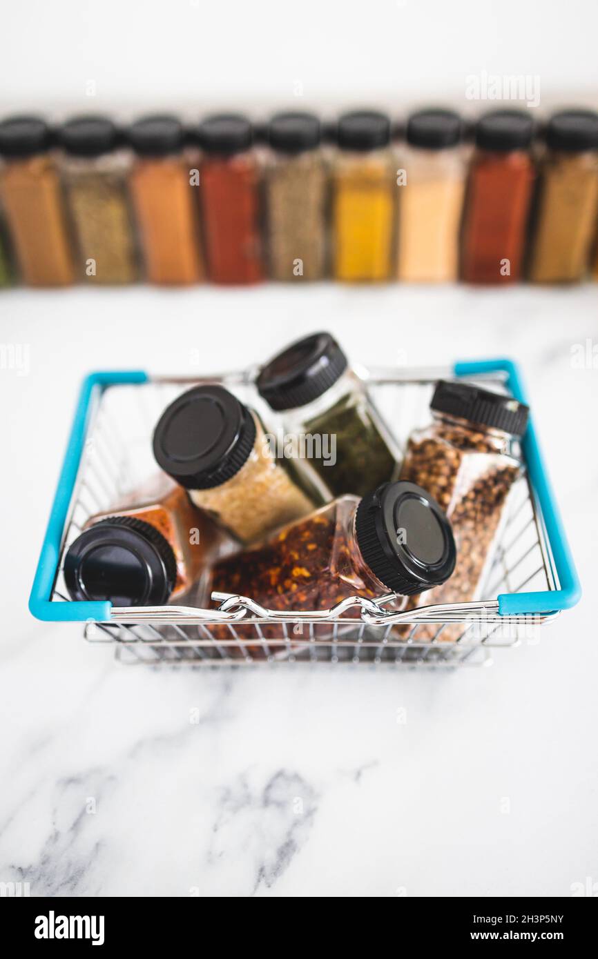 spices and seasonings in matching spice jars in ngrocery shopping ...