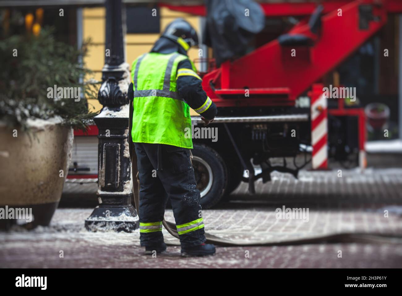 Group of fire men in uniform during fire fighting operation in the city ...