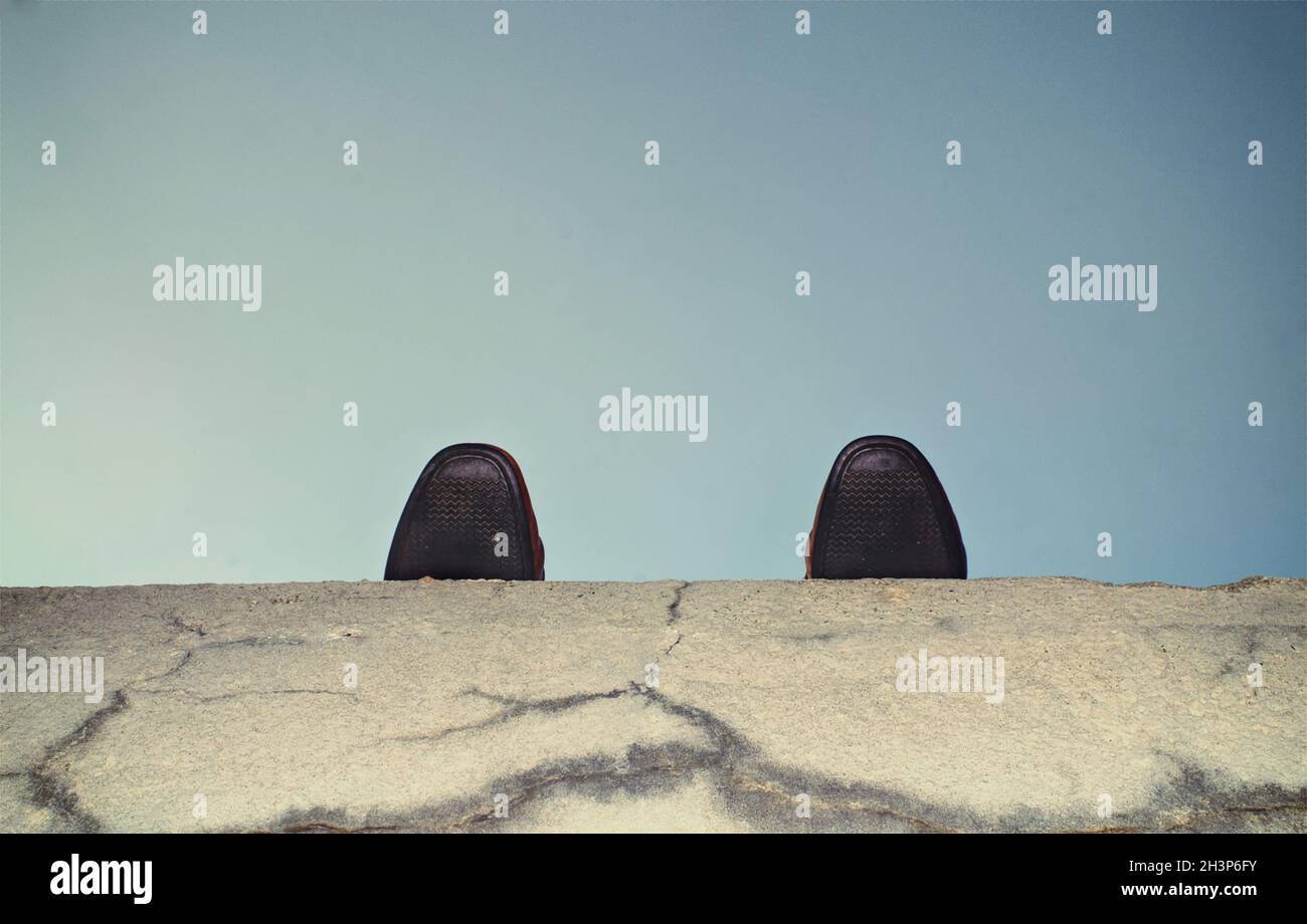 Toes hanging over a ledge Stock Photo - Alamy