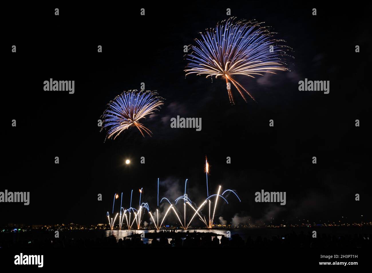 Scenic fireworks glowing in the night for the 14th of July celebrations ...