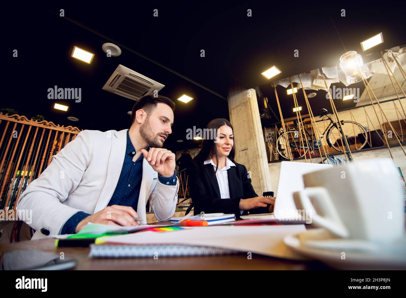 Two business people solving problem after work Stock Photo - Alamy