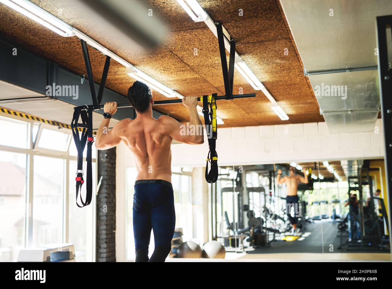 Handsome athlete working out at gym. Pull ups, exercising back. Fitness ...