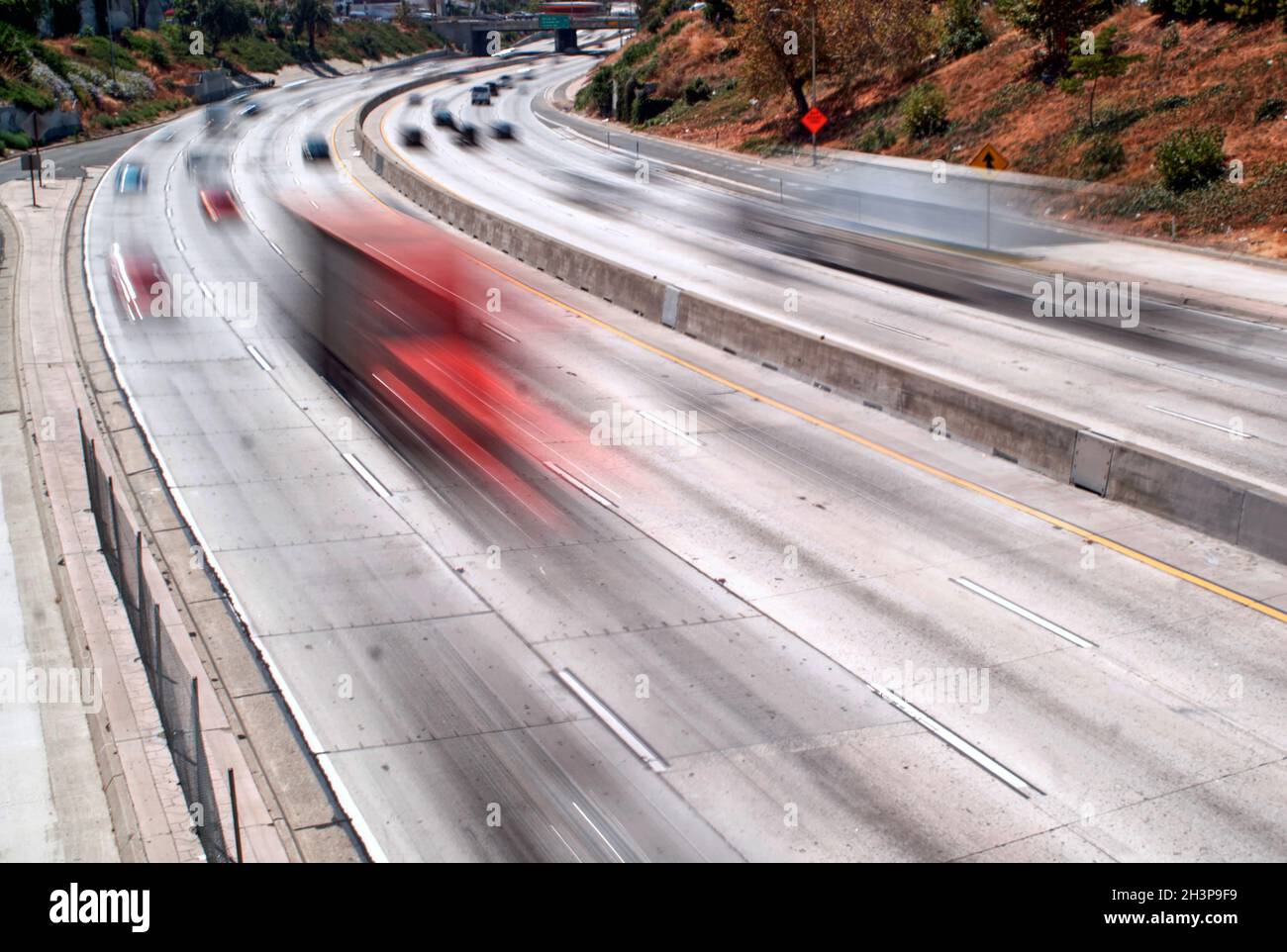 Blurs of vehicles rounding a bend of a freeway Stock Photo - Alamy