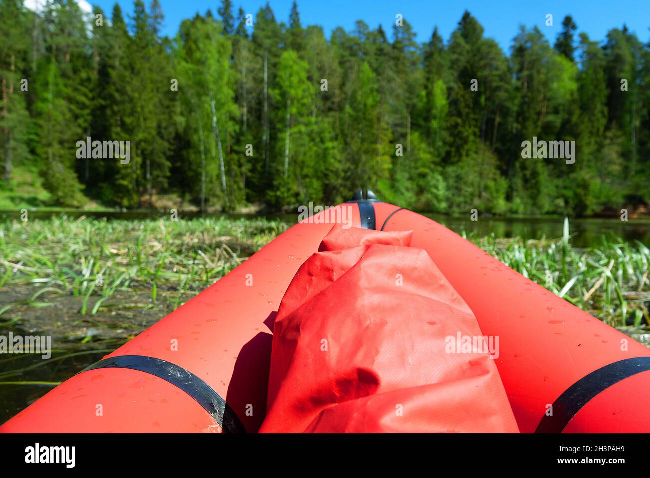 Travel on a red inflatable kayak on the spring river Stock Photo - Alamy