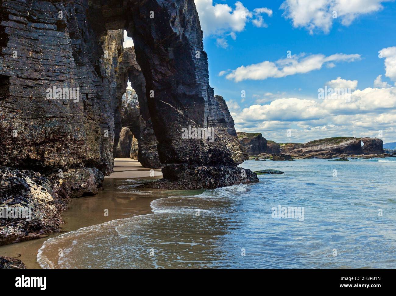 Natural arches on beach Stock Photo - Alamy