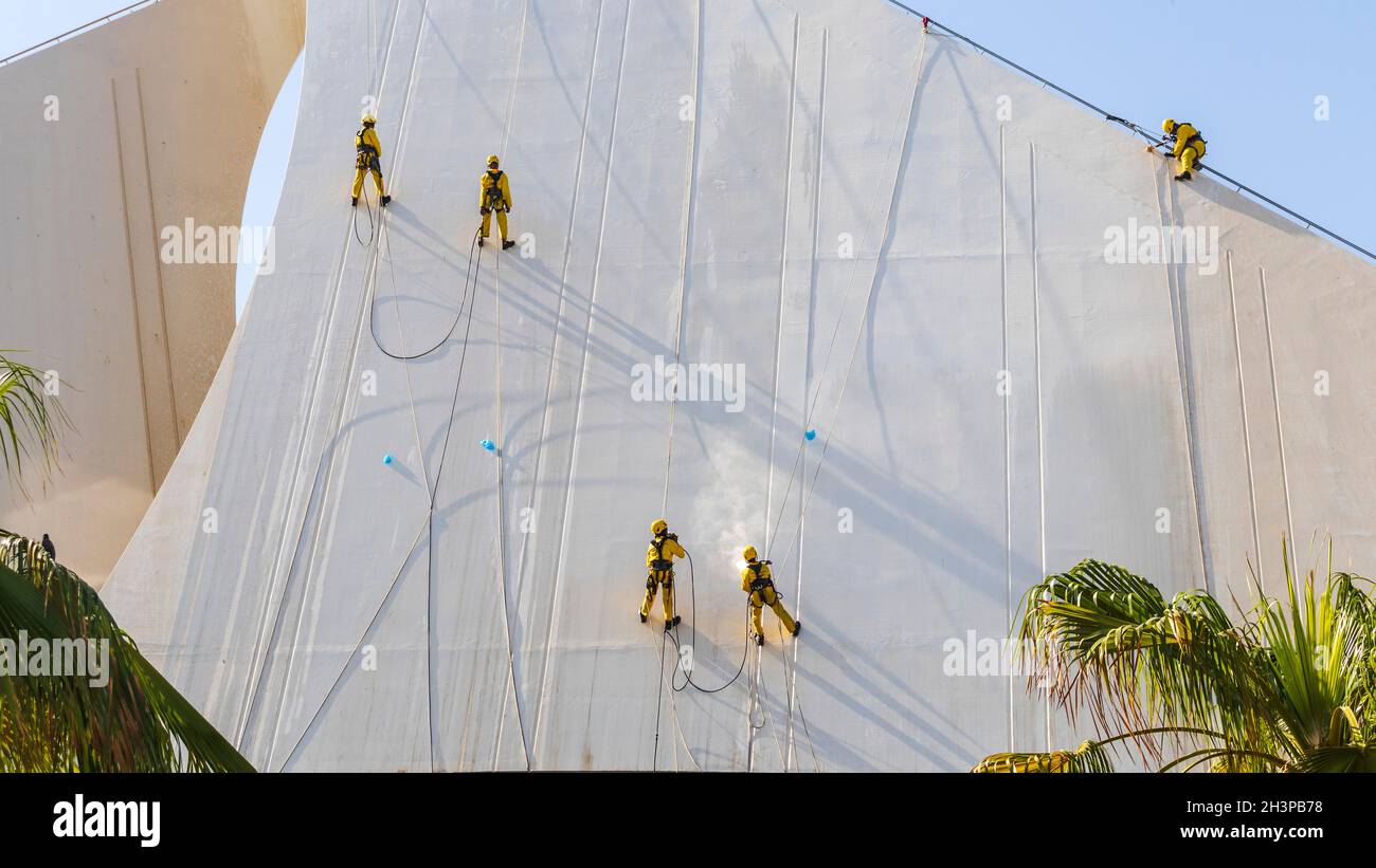 Workers cleaning facade of building with water jet pressure method ...