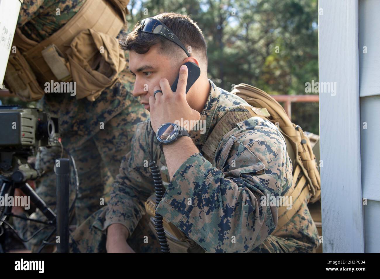 U.S. Marine Corps Sgt. Daniel Holtz sets up a communications system ...
