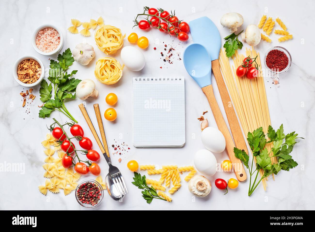 Pasta cooking background with notepad for text, tomatoes, herbs ...