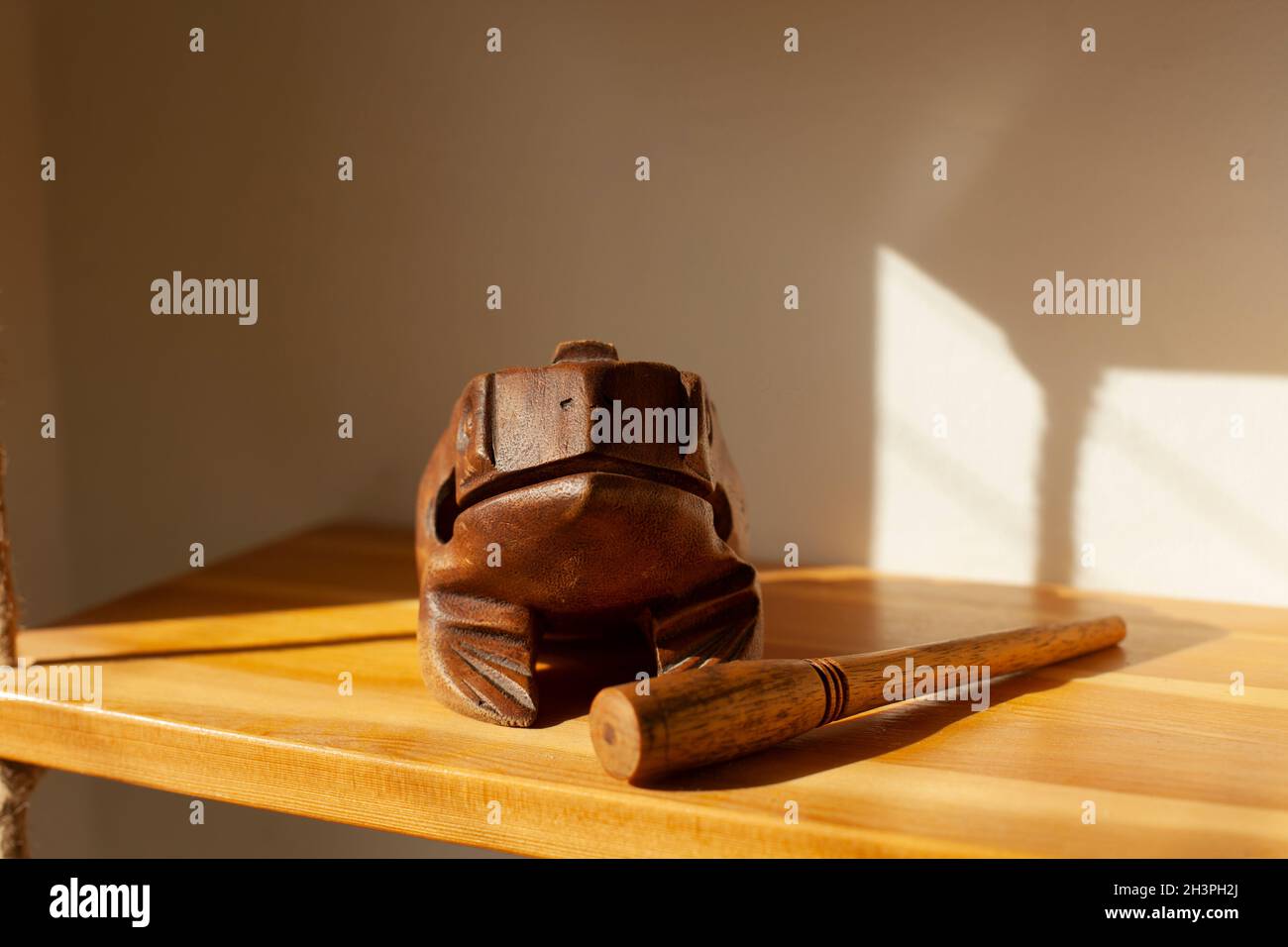 Wooden frog. Musical instrument made of wood. Stick and frog with teeth ...