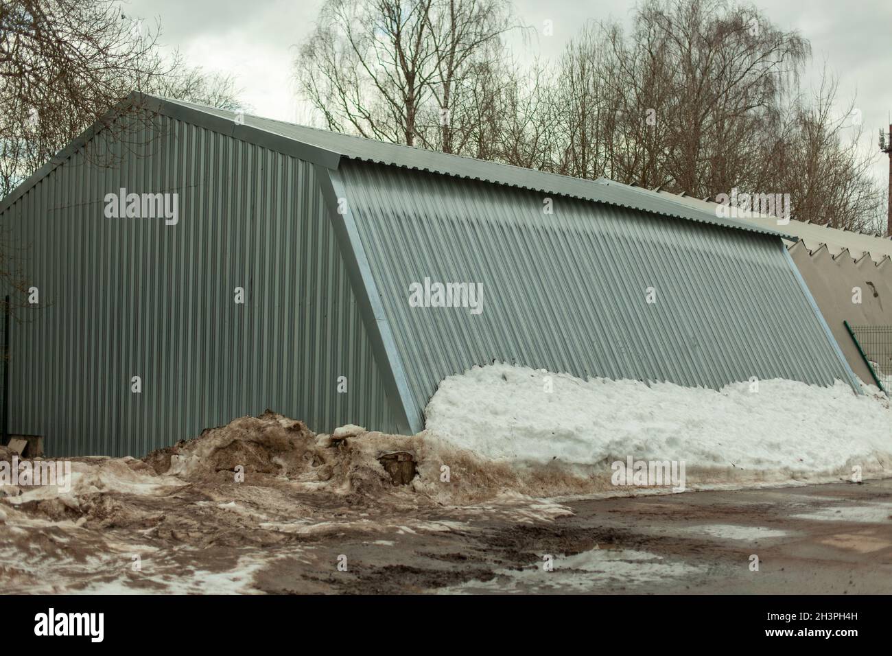 Metal warehouse outside. Storage room for municipal equipment. Snow ...
