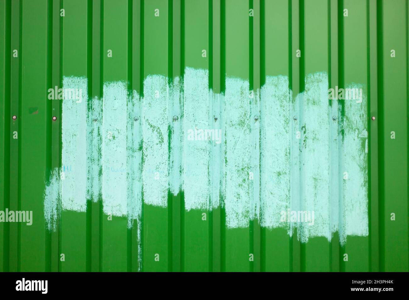 Fence painted after vandalism. Painting over graffiti on the fence ...