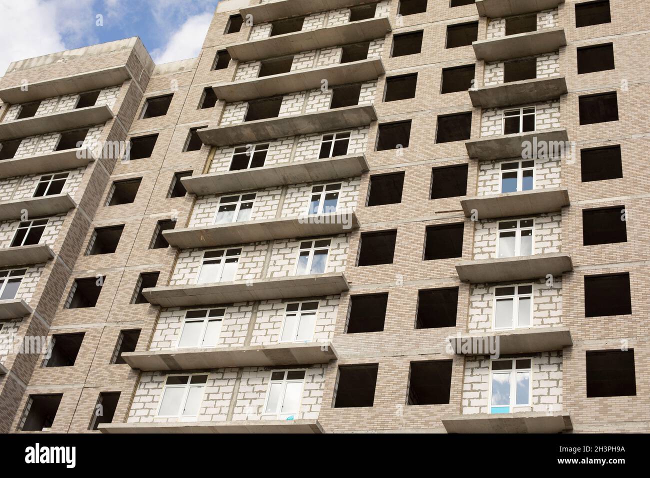 Unfinished building. House without cladding. Window openings without ...