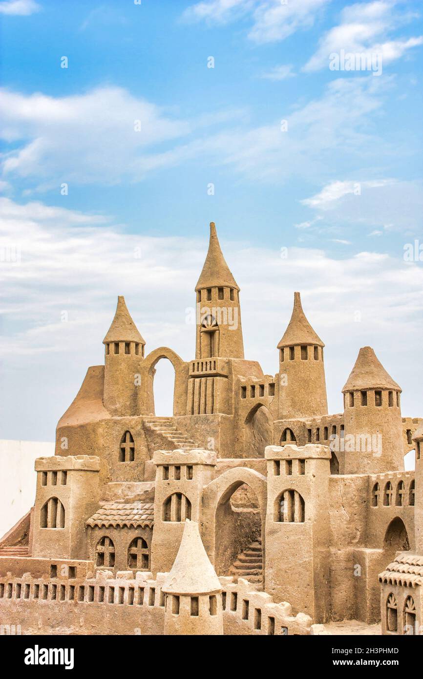 Sandcastle during a sunny day with blue sky background. Concept for ...