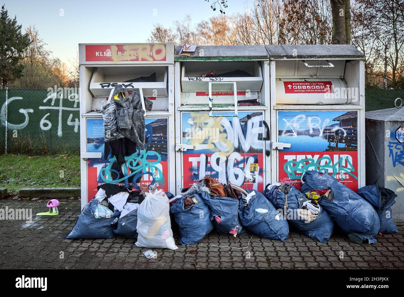 Overfilled collection containers for used textiles Stock Photo - Alamy