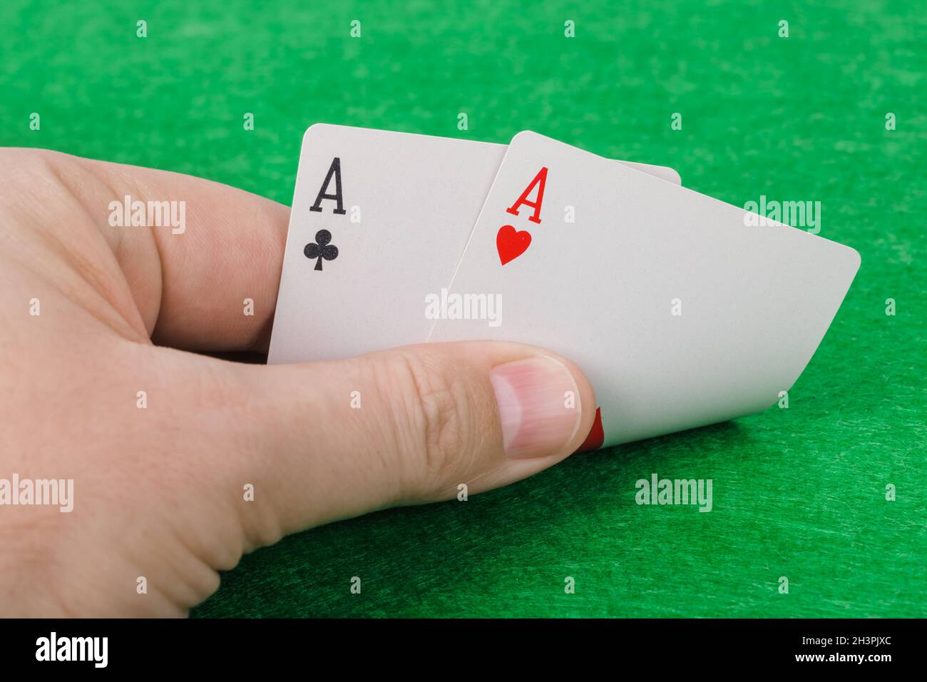 Hand with playing cards in casino Stock Photo - Alamy