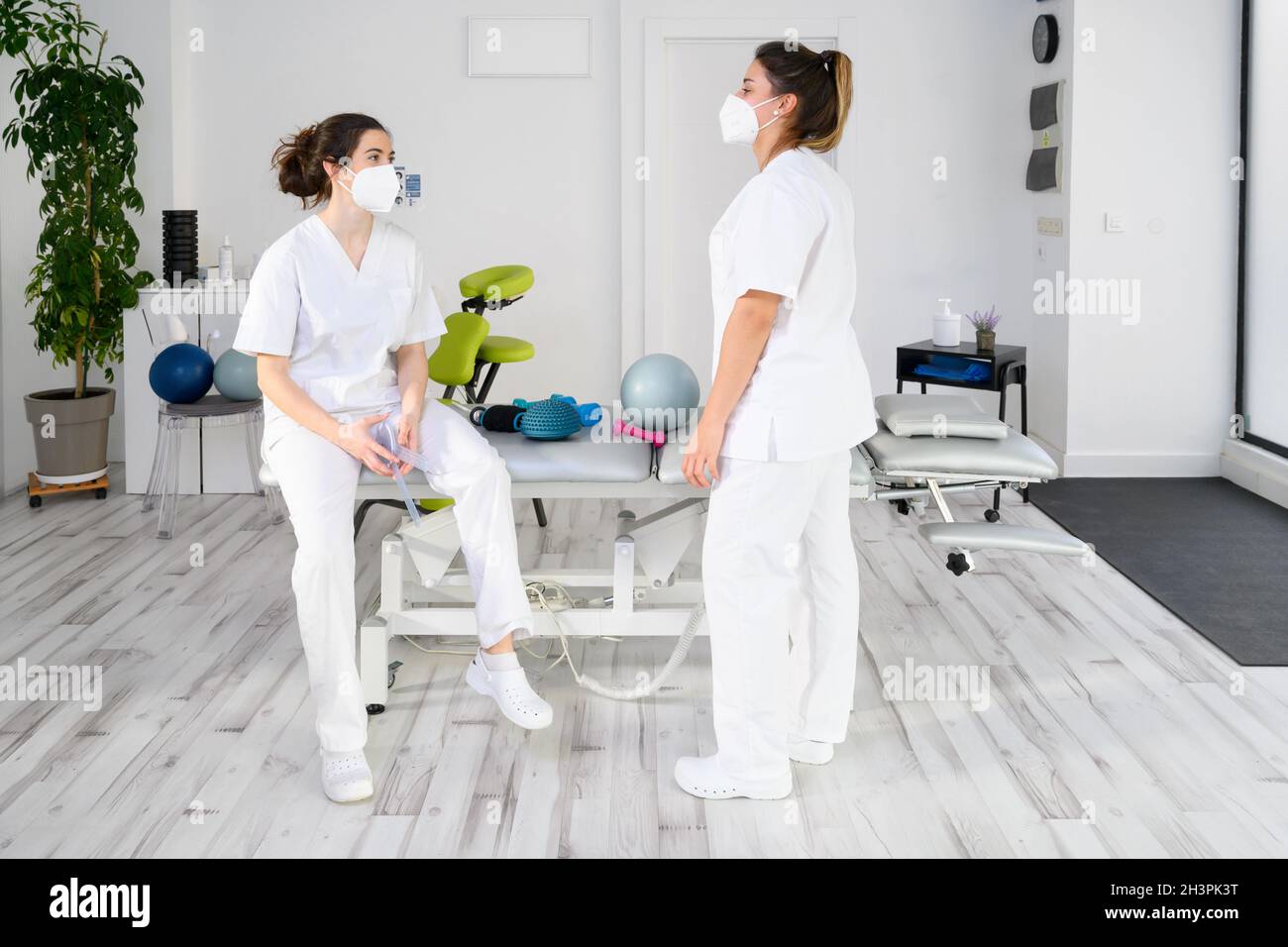 Team of physiotherapists practicing exercises for helping patients ...