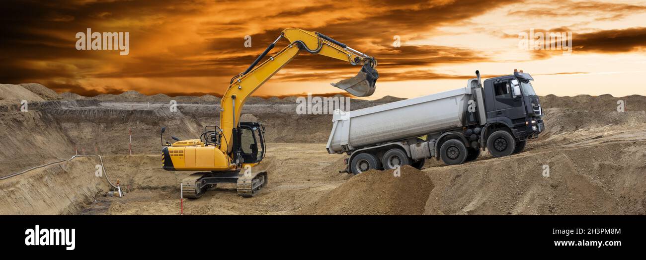 Excavator at work on construction site Stock Photo - Alamy