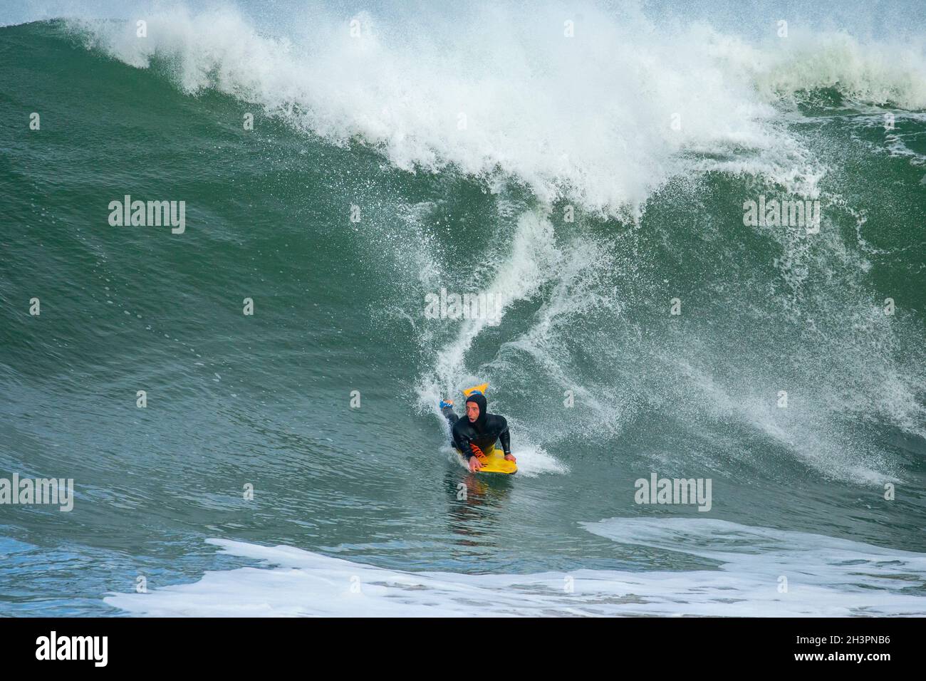 Surfing at Portrush as a big wave storm comes in off the Atlantic Ocean ...