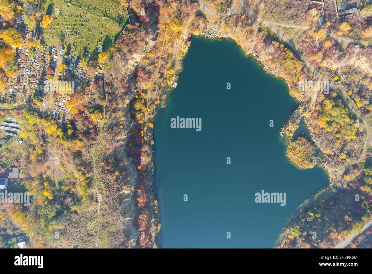 Aerial top view an quarry pond formed during mining stone with ...
