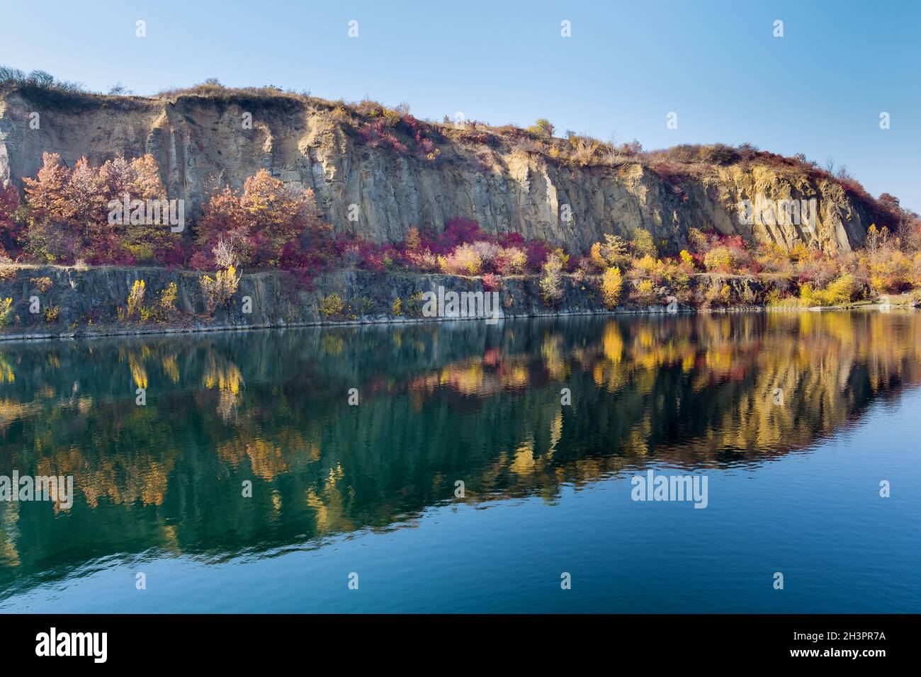 Aerial top view an quarry pond formed during mining stone with ...