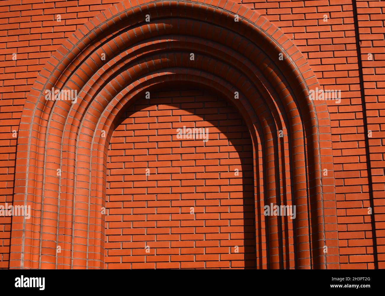Arch red brick wall. arch texture background Stock Photo - Alamy