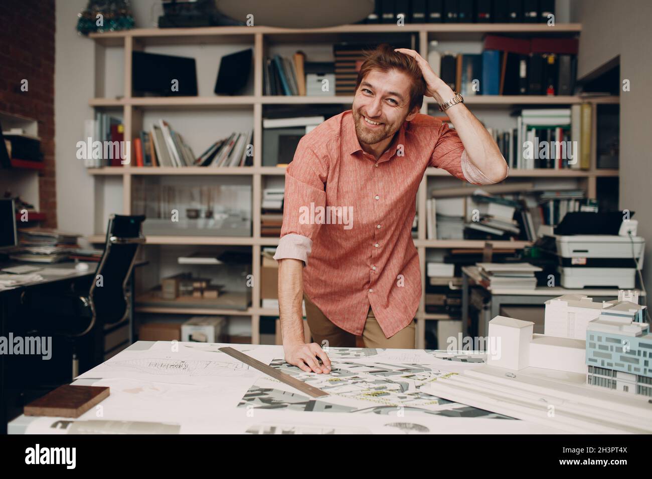 Architect smiling with blueprints and layout design project at office ...