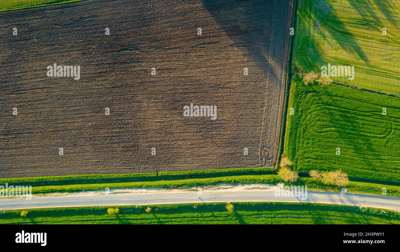 Aerial view geometric farming fields, showing a green meadow and plowed ...