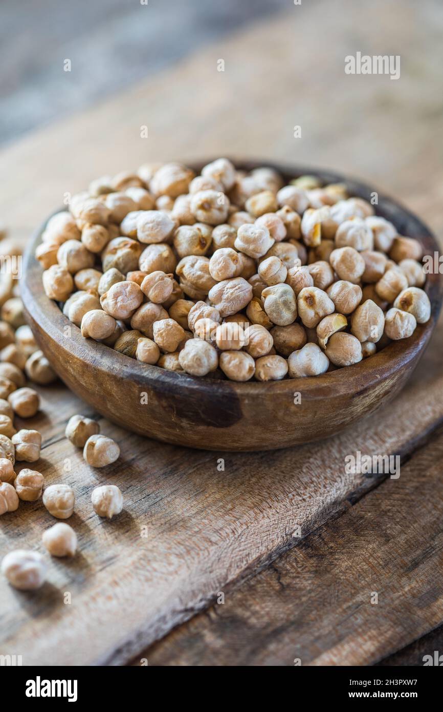 Raw chickpeas in a wooden bowl. Legume dietary fibers and vegetable ...