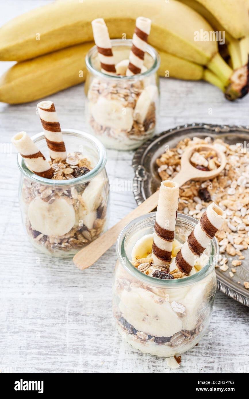 Layer dessert with muesli, chocolate and banana fruits. Party dish ...