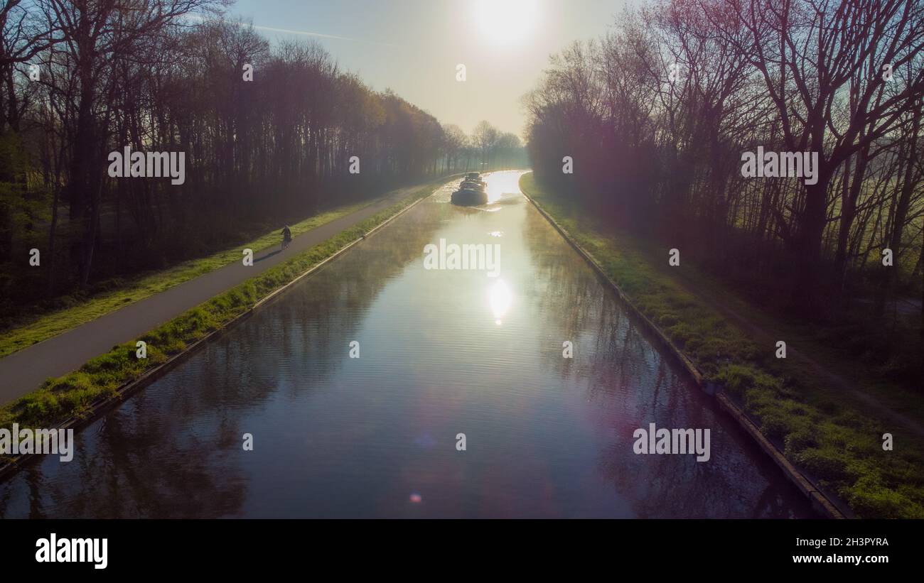 Aerial view of an Idillic river stream canal with a boat or ship in the ...