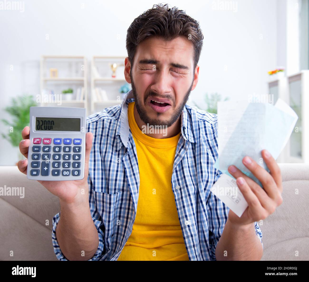 Man angry at bills he needs to pay Stock Photo - Alamy