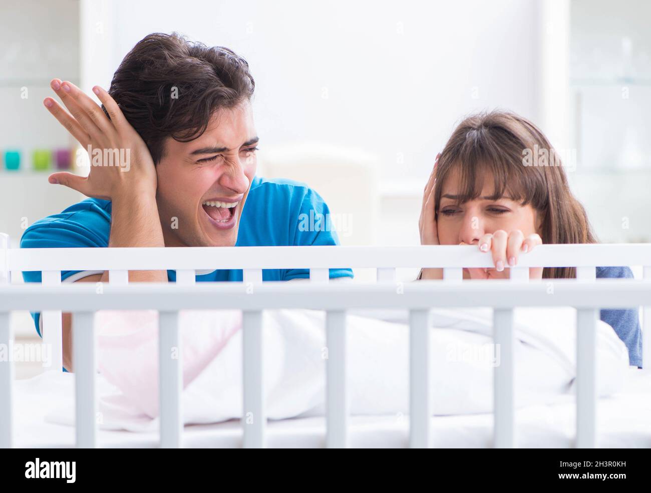 Young family frustrated at baby crying Stock Photo - Alamy