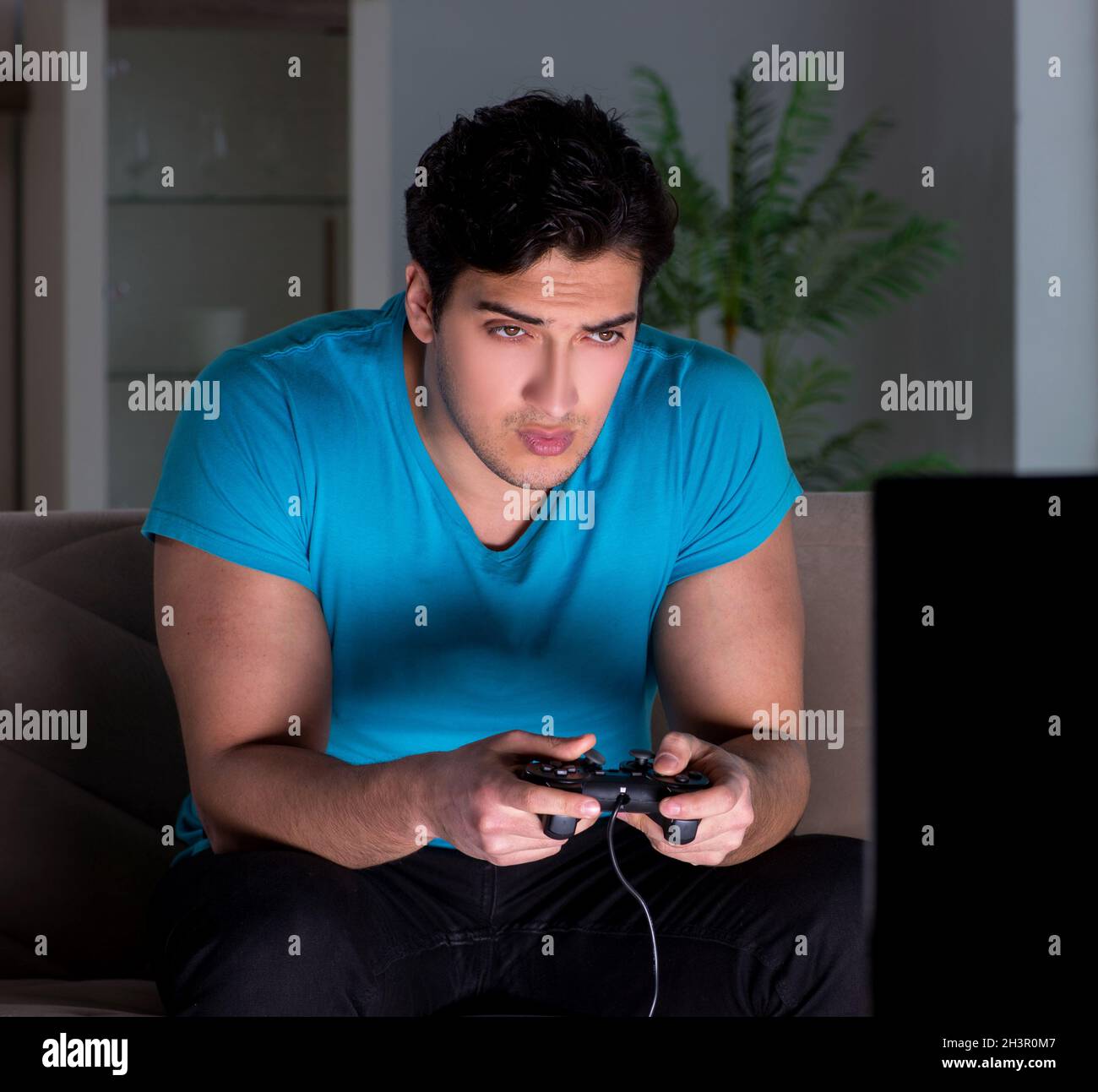 Young man playing computer games late at night Stock Photo - Alamy