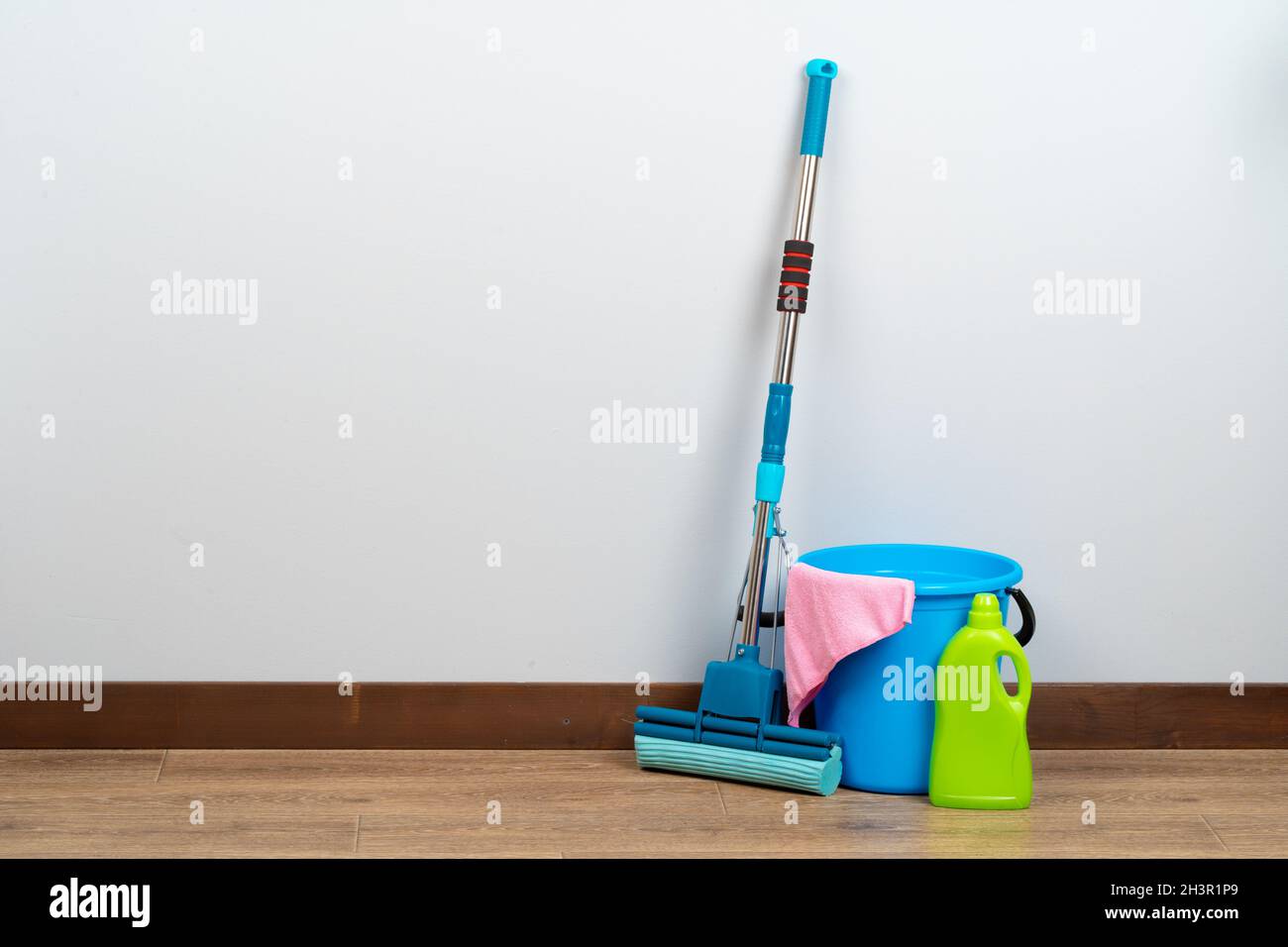 Cleaning tools for house cleaning on wooden floor Stock Photo - Alamy