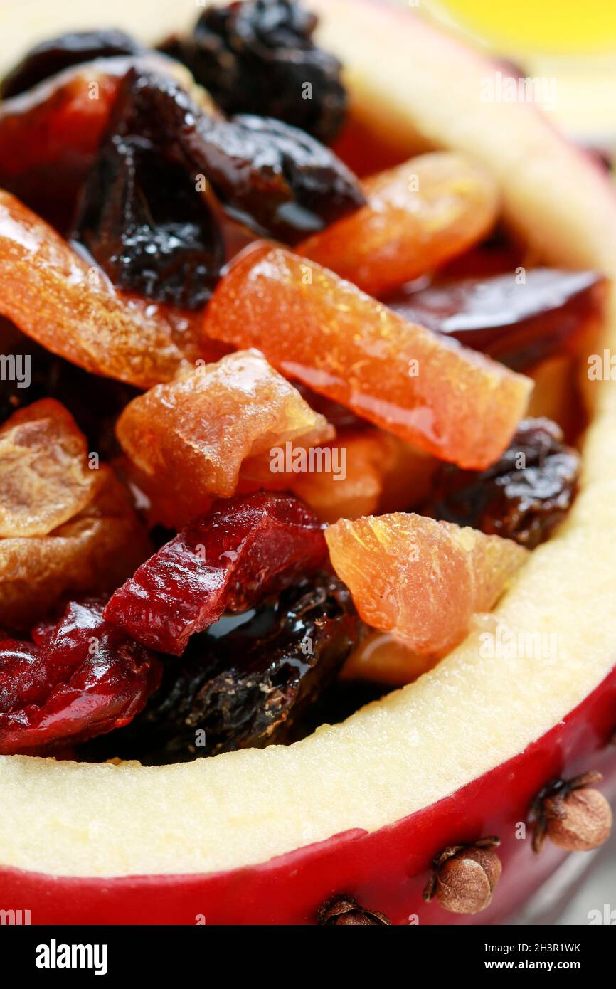 Red christmas apple stuffed with dried fruits in honey. Healthy food ...