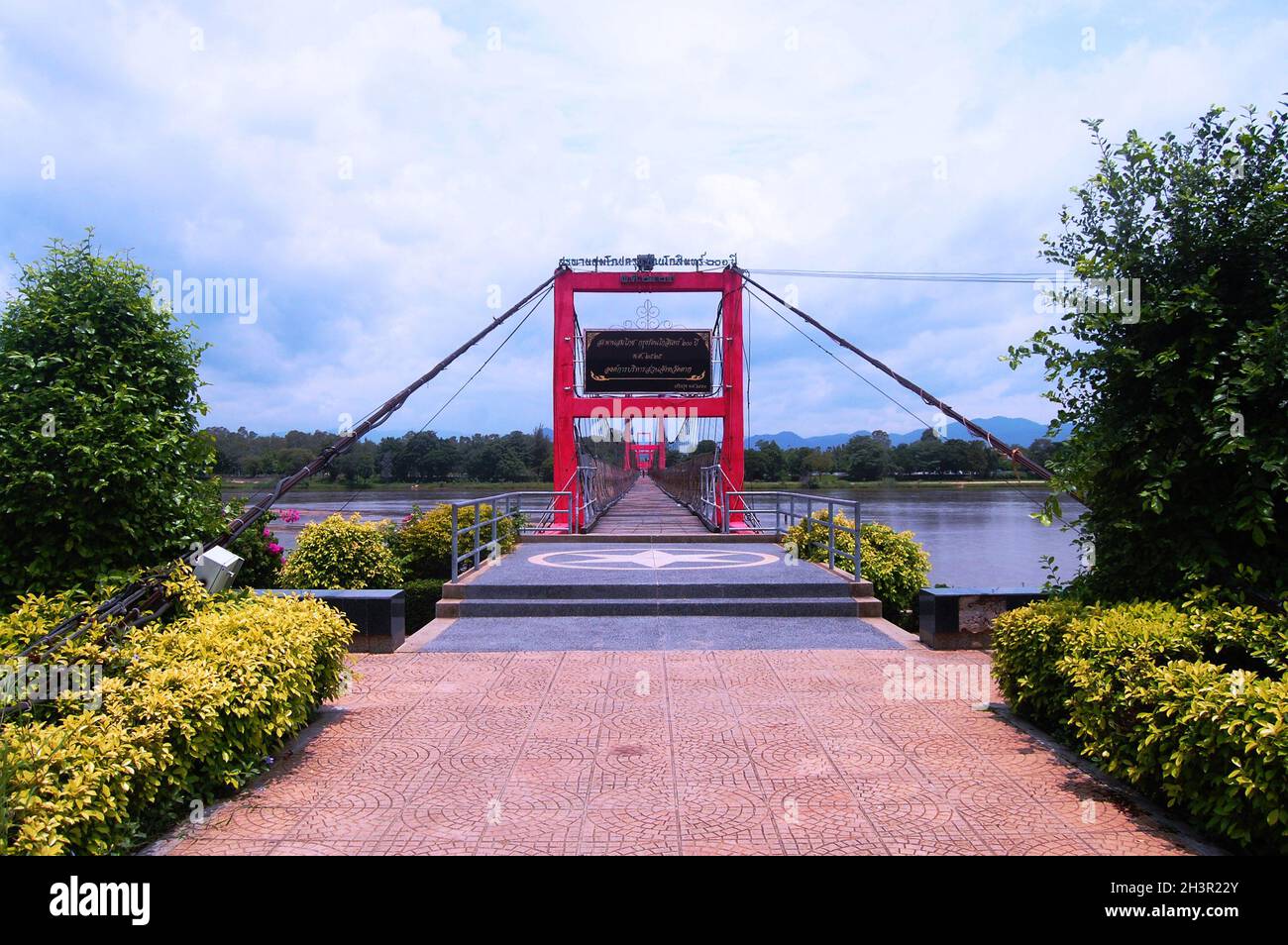Building stone red suspension bridge crossing Ping river for thai ...