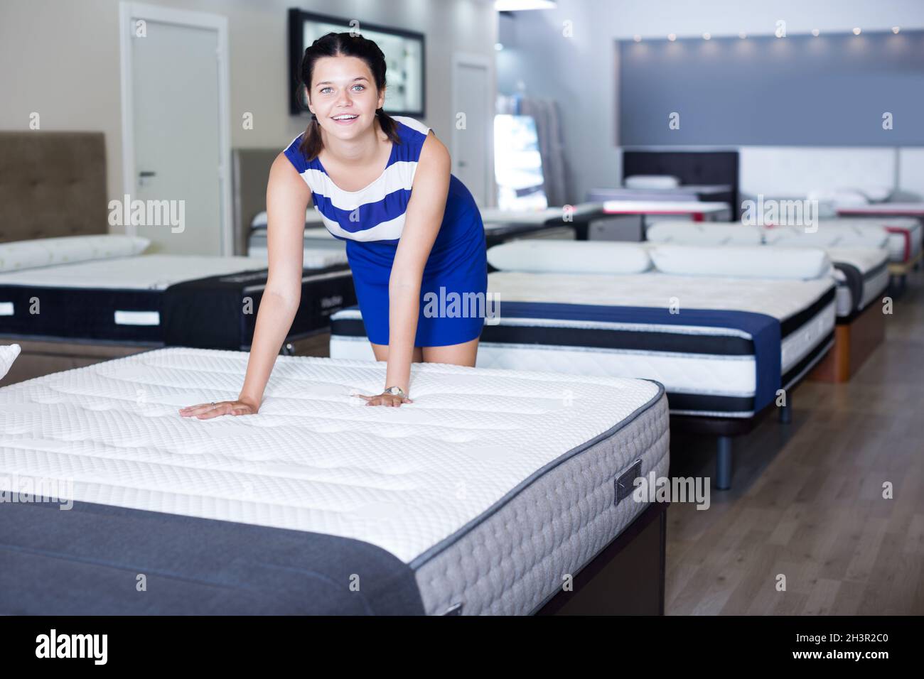 woman testing mattress Stock Photo - Alamy