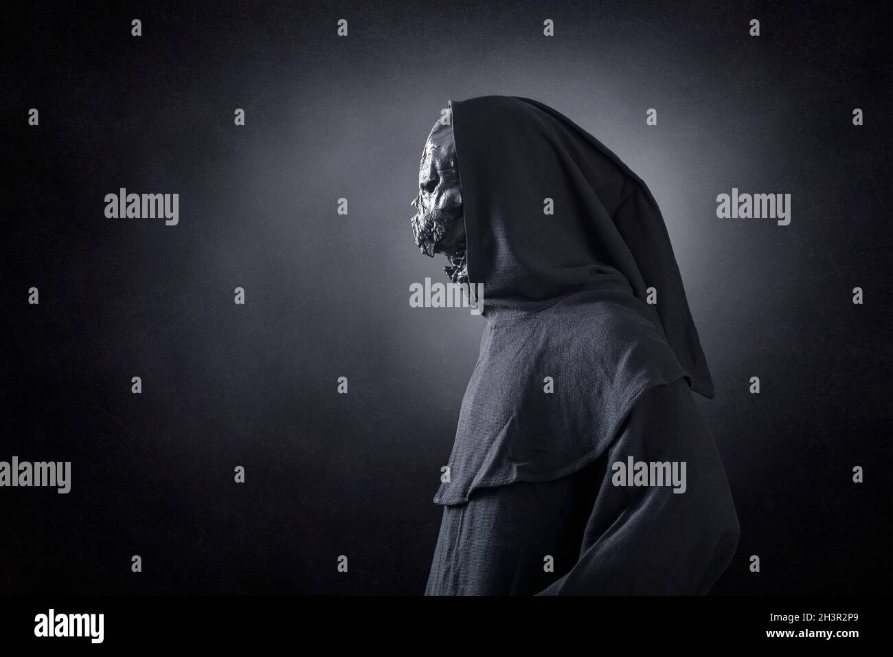 Monster in hooded cloak at night Stock Photo - Alamy