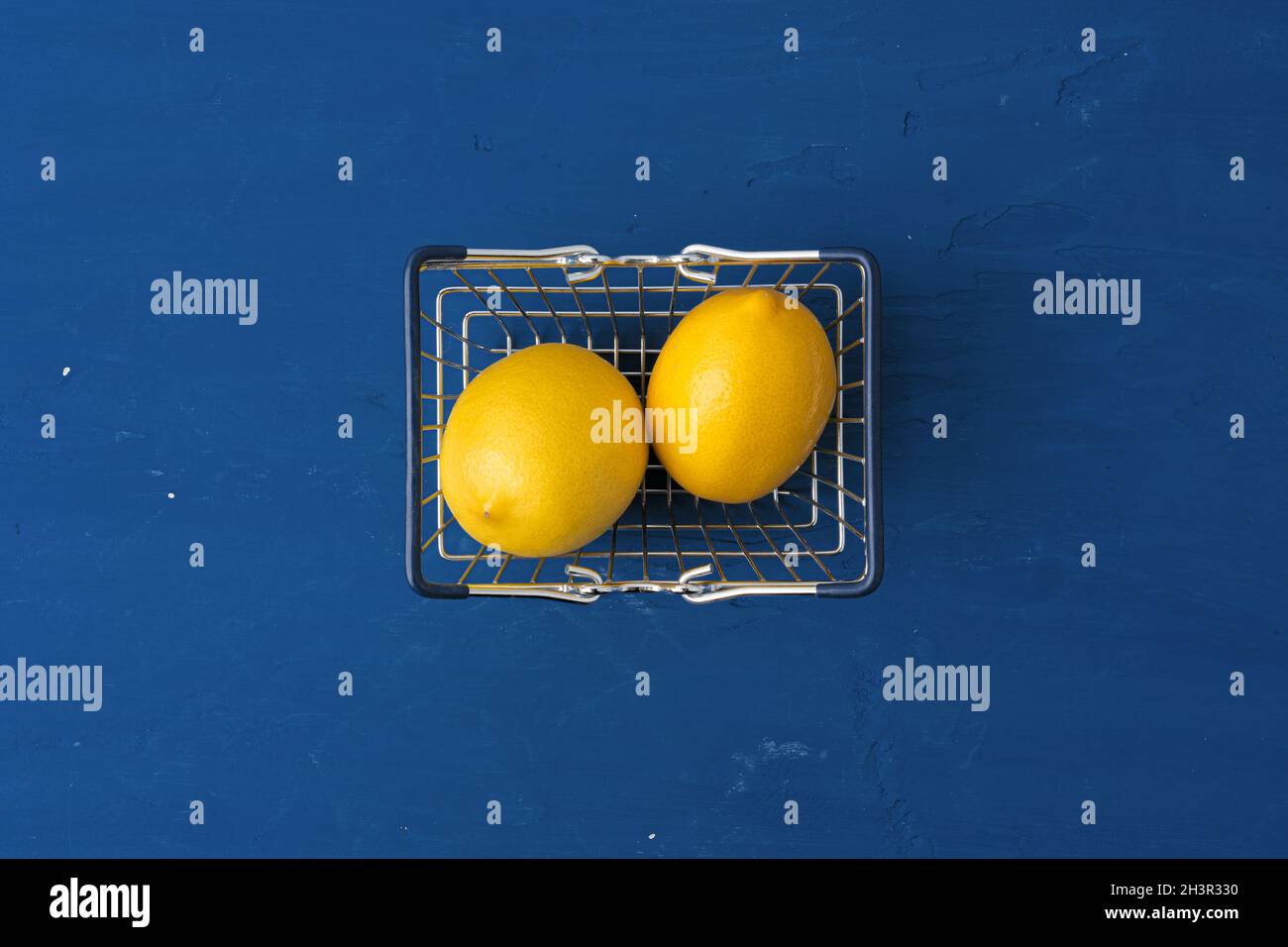Lemon in shopping cart on classic blue background, top view Stock Photo ...