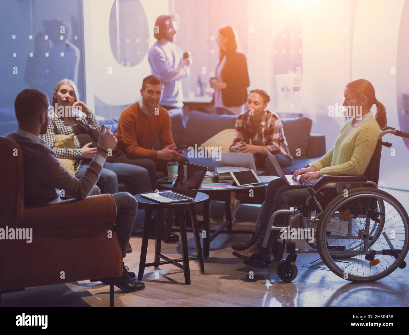 Handicapperd businesswoman in a wheelchair on meeting with her diverse ...
