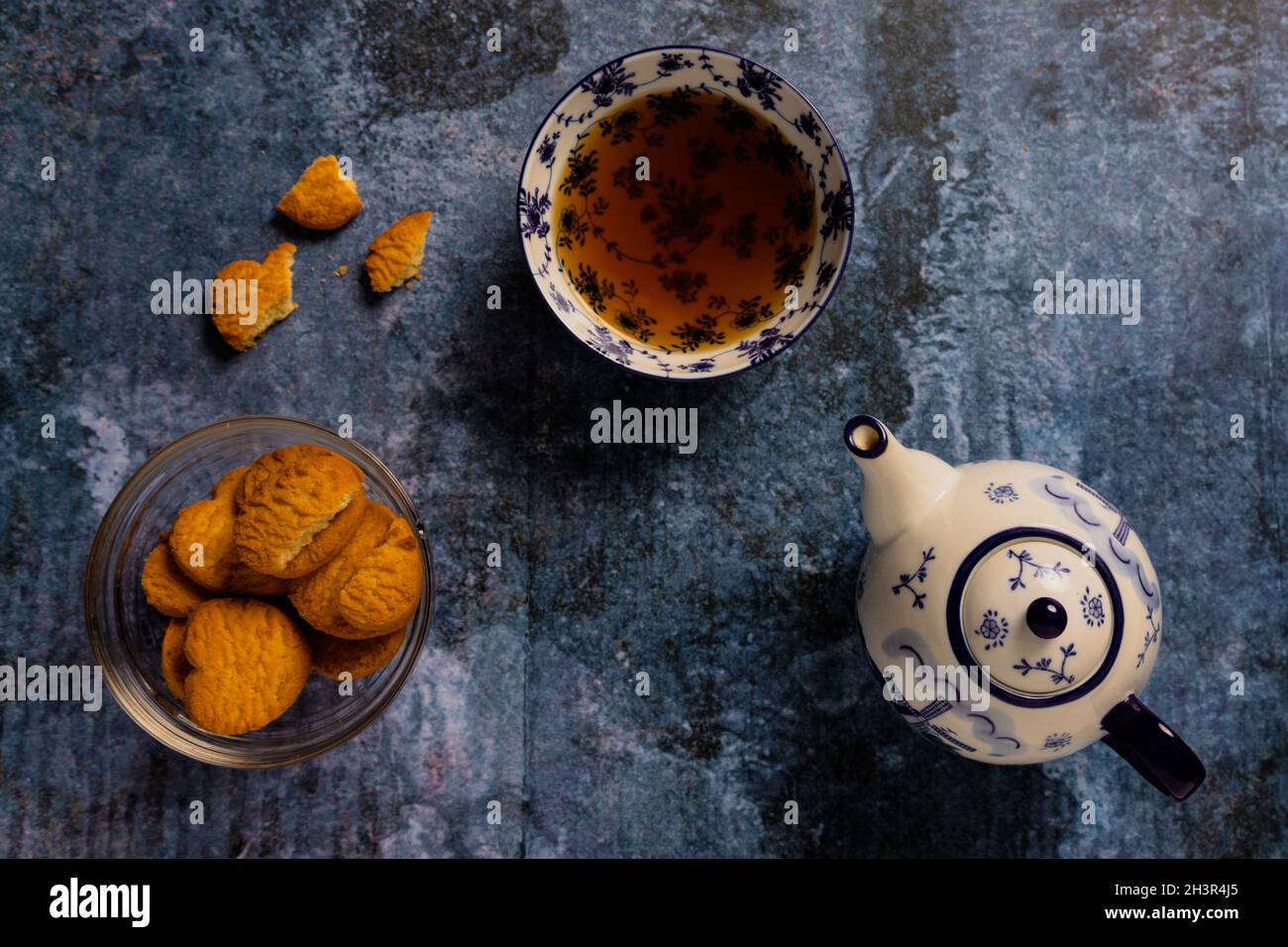 Calm China tea set with yummy biscuits on the blue table. Relaxing time ...