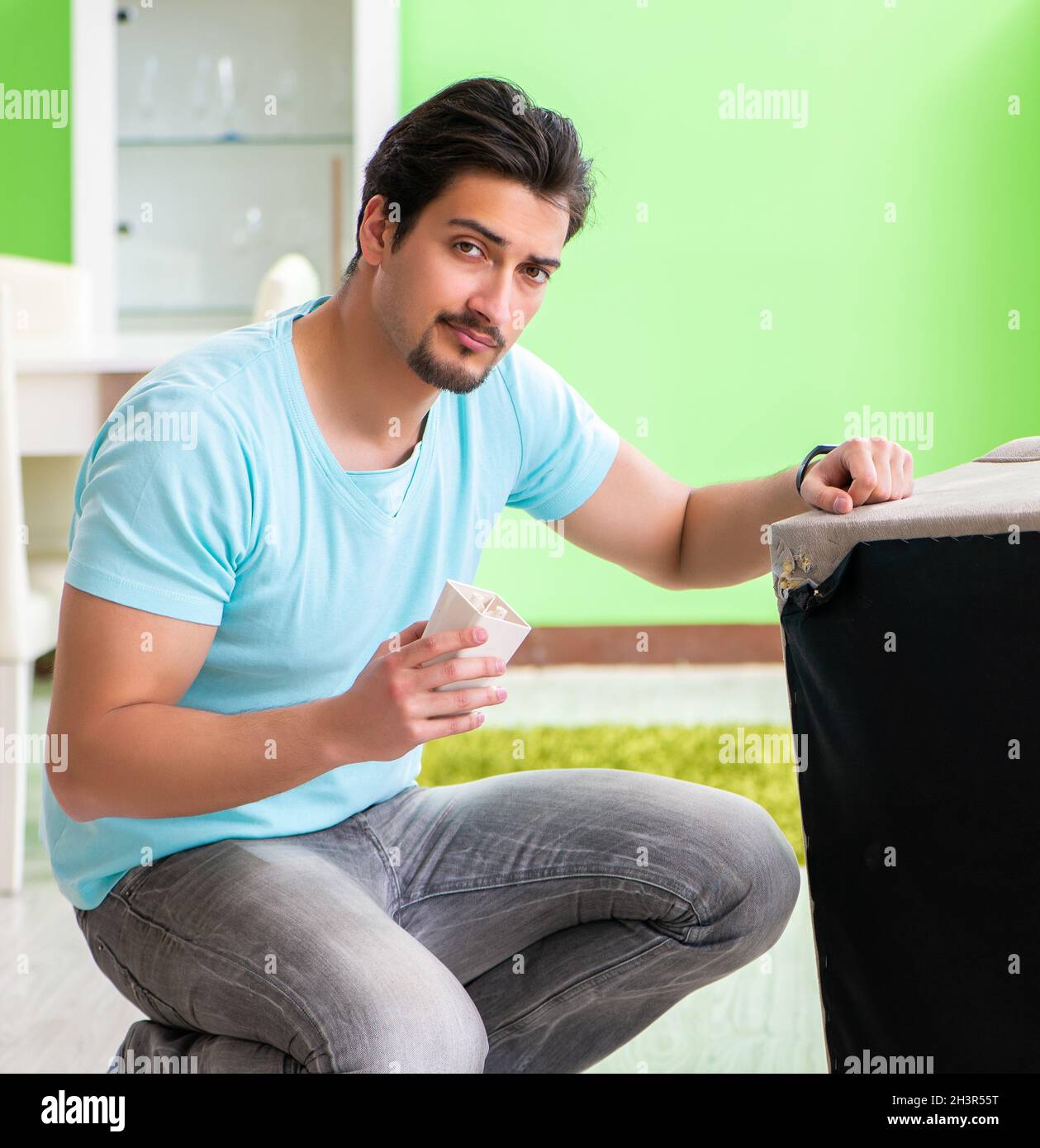 Male worker repairing table hi-res stock photography and images - Alamy