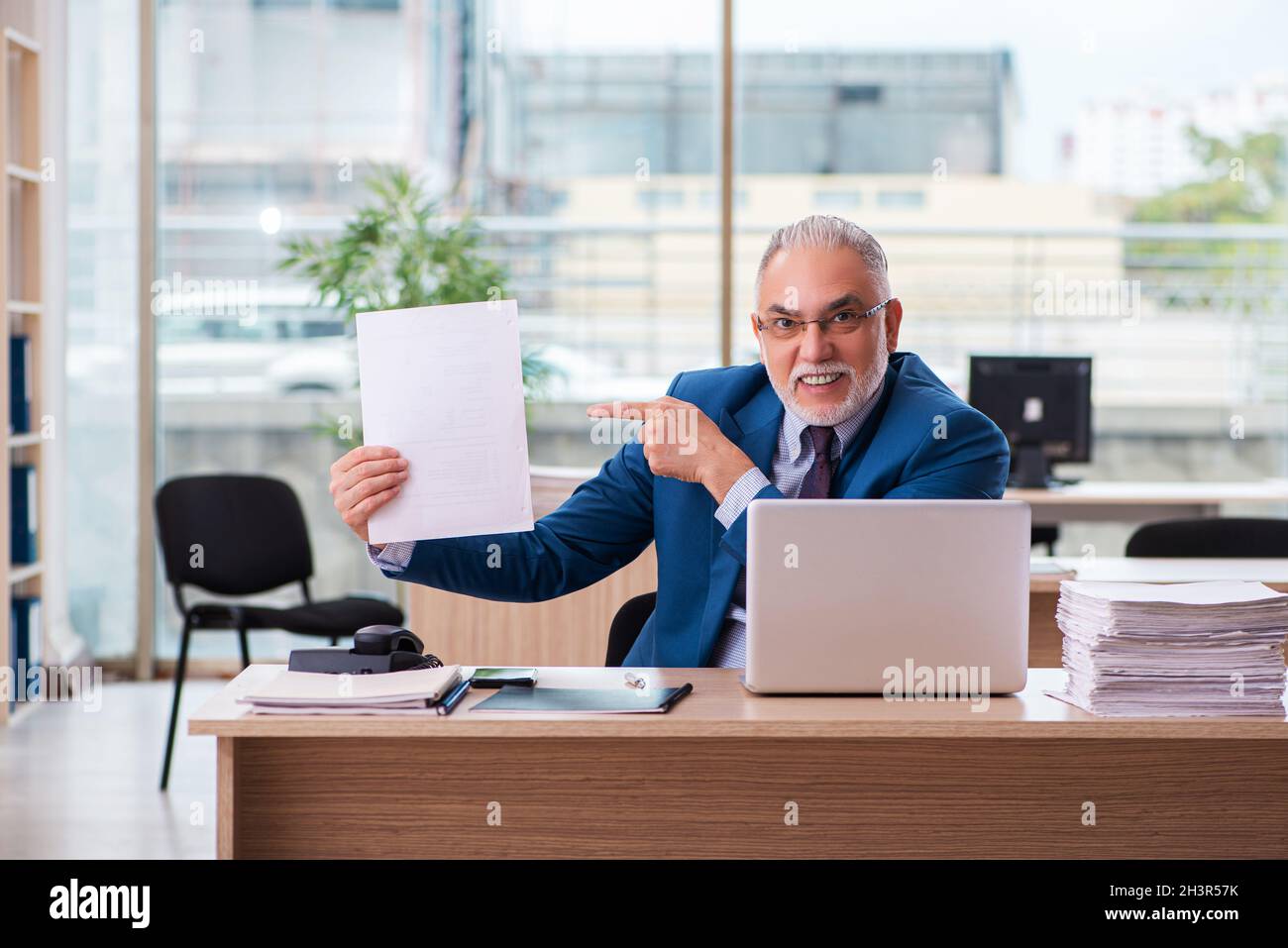 Old male boss employee working in the office Stock Photo - Alamy