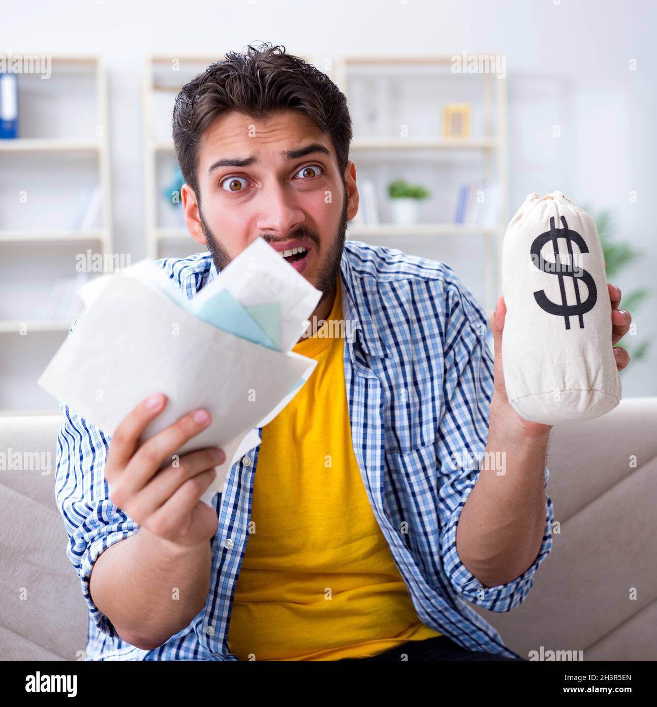 Man angry at bills he needs to pay Stock Photo - Alamy