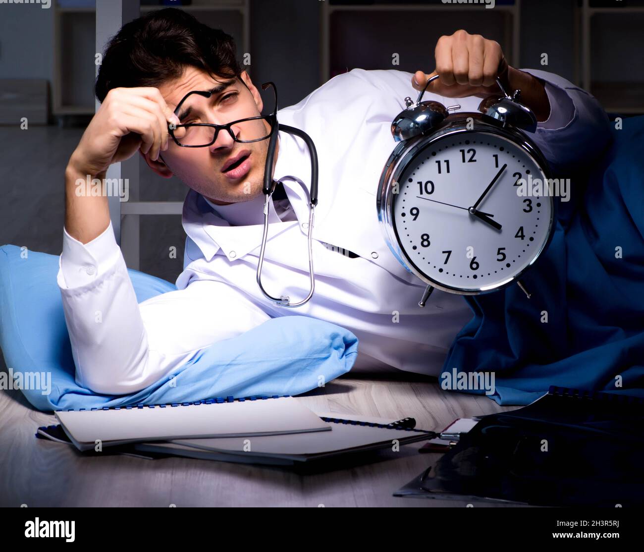 Doctor working night shift in hospital after long hours Stock Photo - Alamy