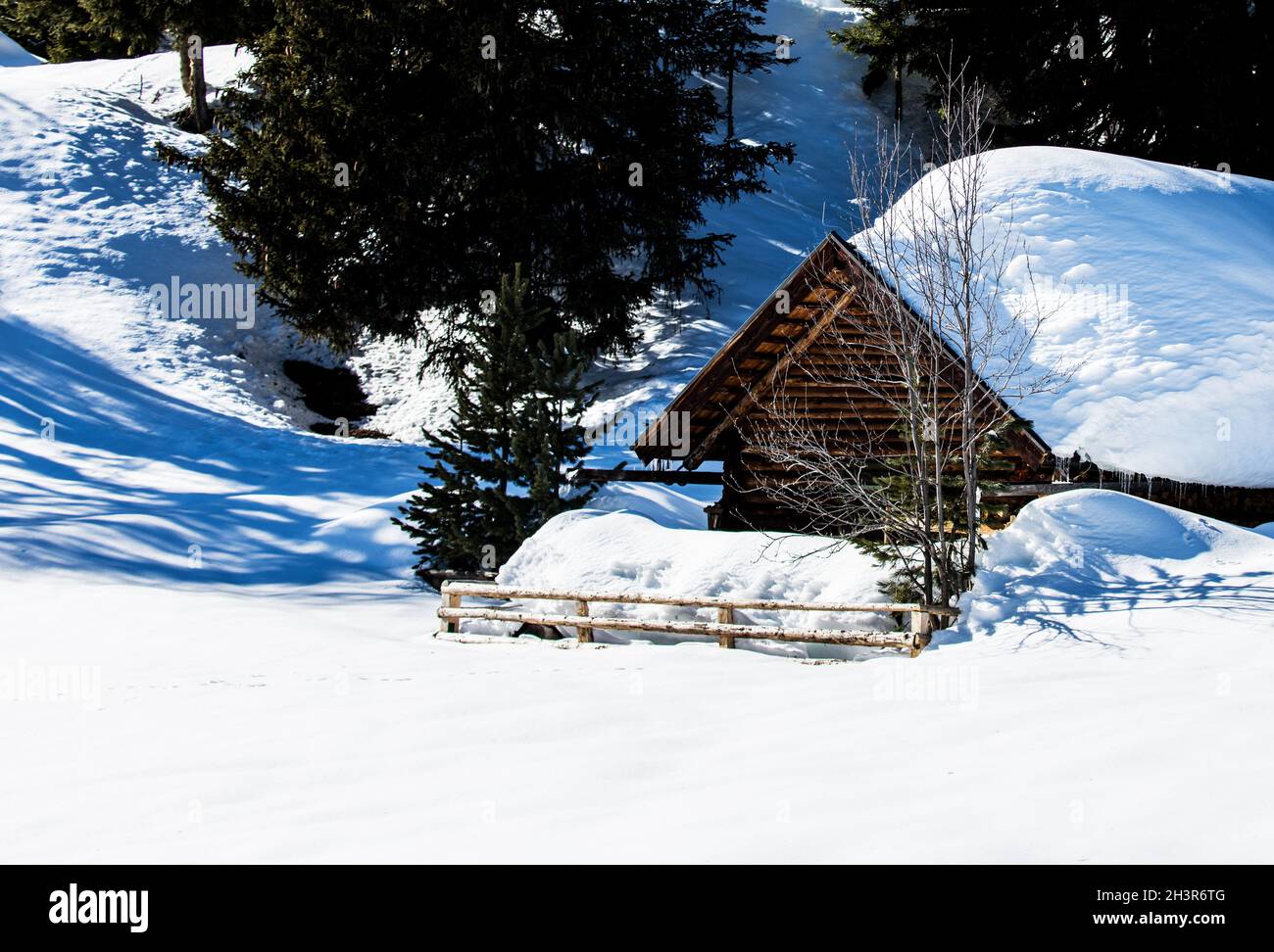 romantic wooden hut in deep snowy winter landscape in Tirol with big ...