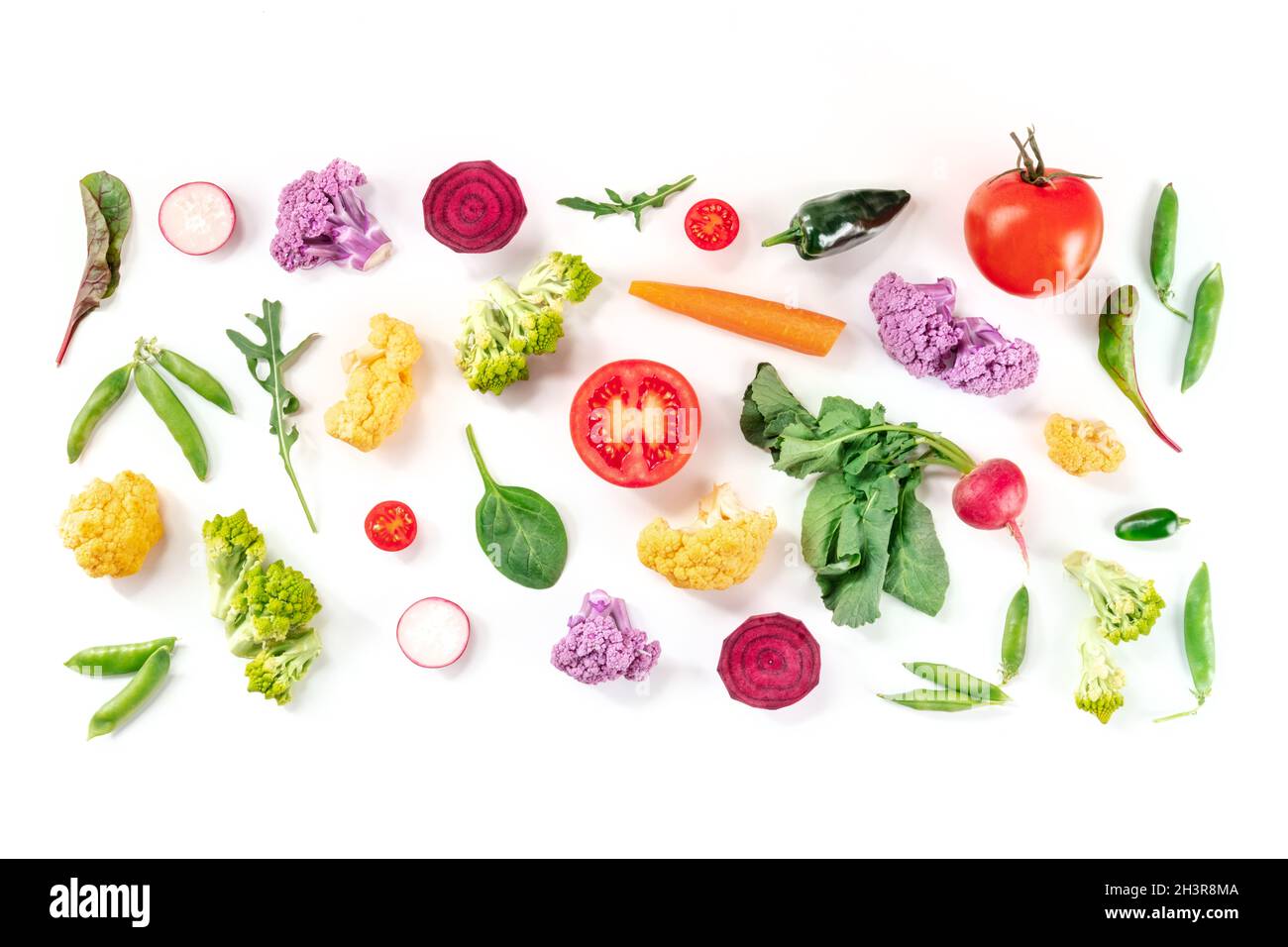 Fresh vegetables overhead flat lay composition on a white background ...